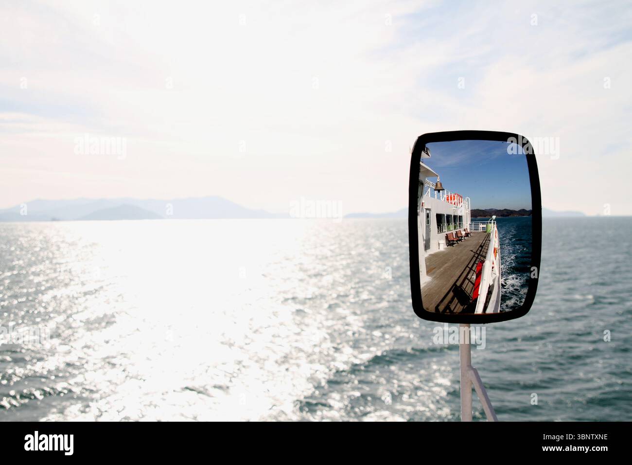 Ferry boat journey back view reflection in mirror on calm ocean Stock ...