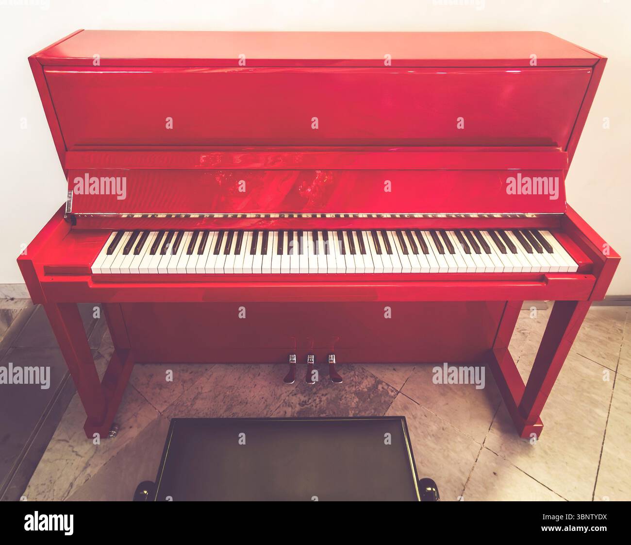 Front View of Red Upright Piano on Marble Floor Stock Photo - Alamy