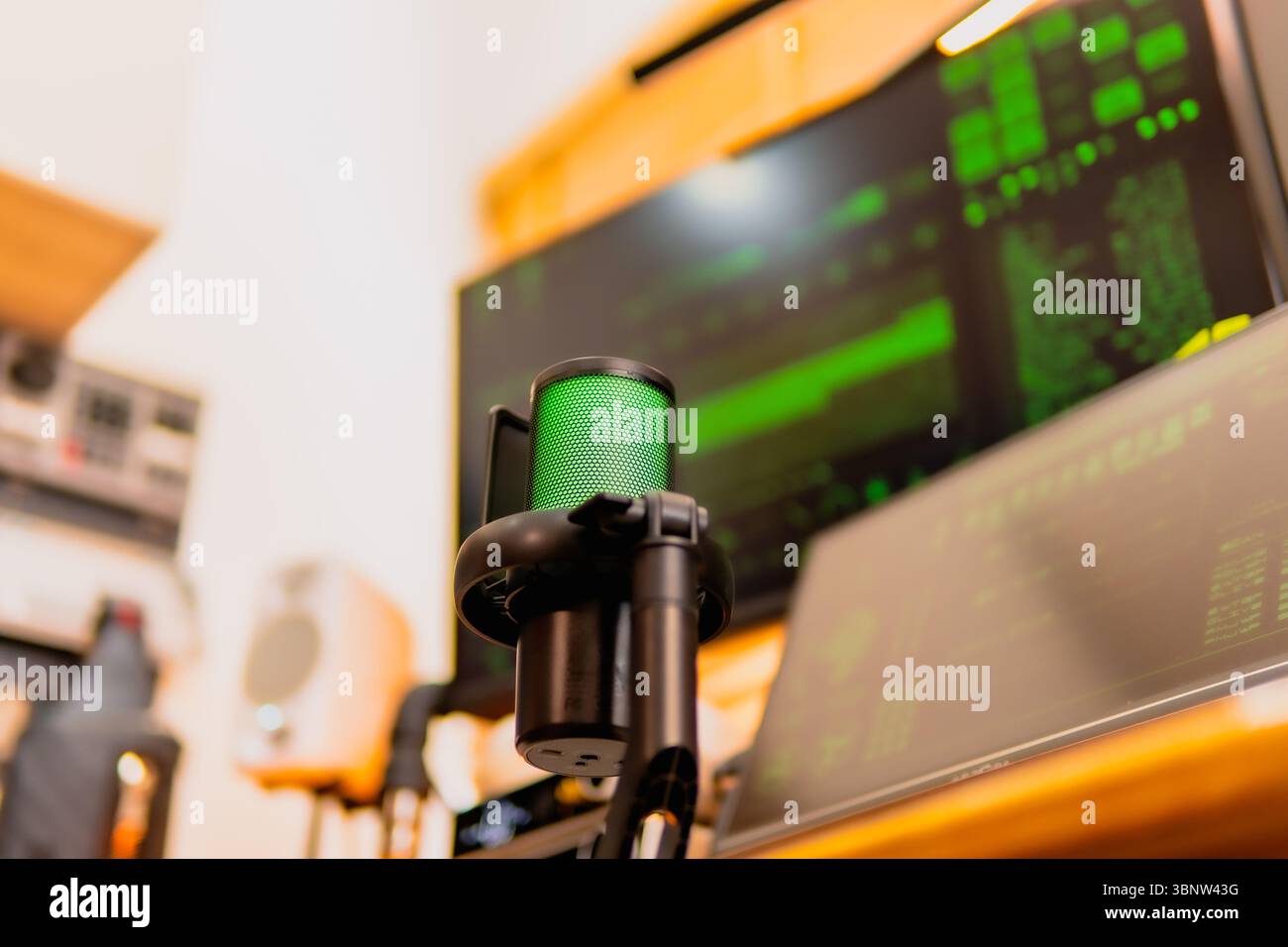A close-up of a black microphone with green LED lighting, placed in ...