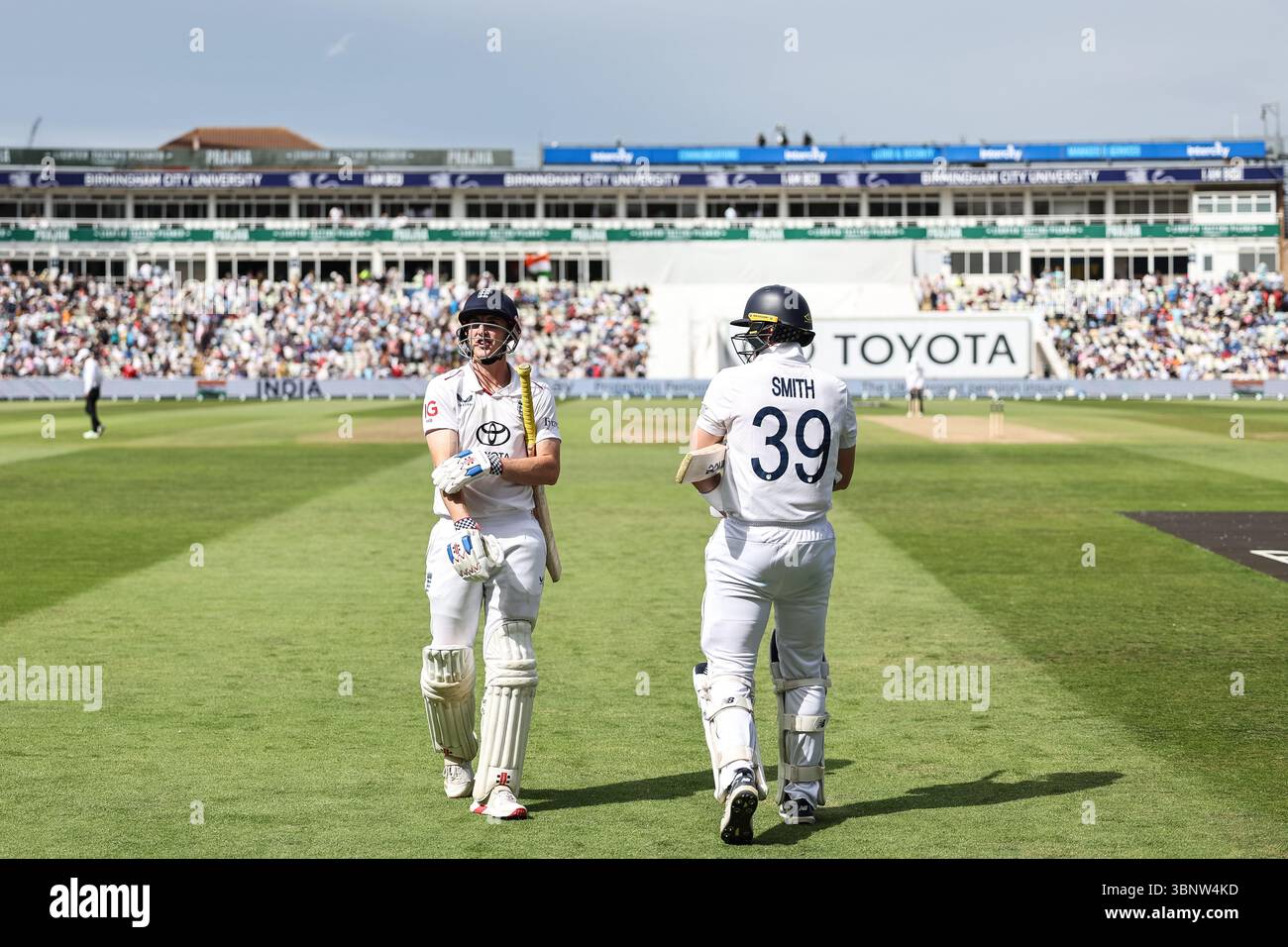 Harry Brook of England and Jamie Smith of England walk out to bat after ...
