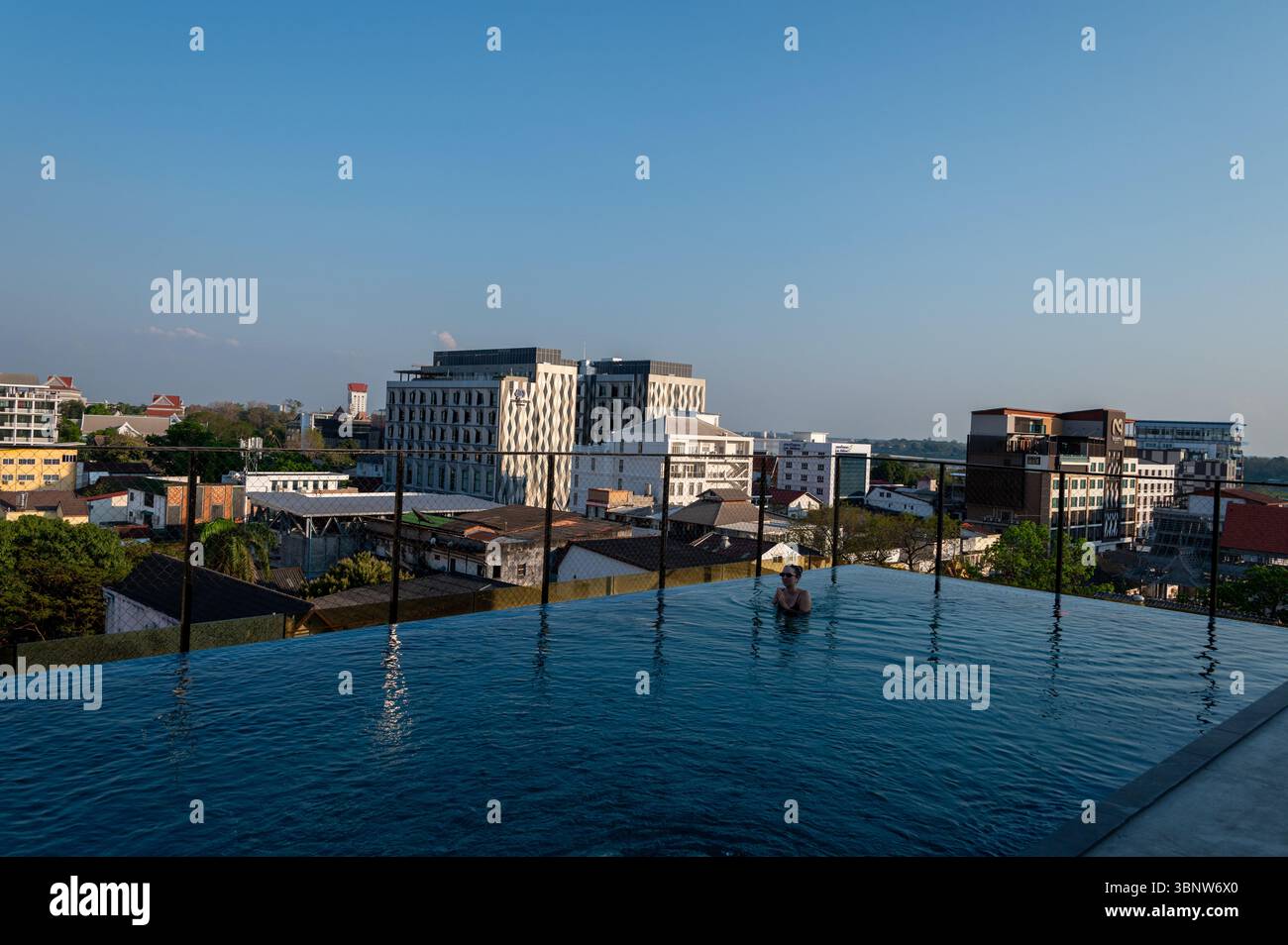 From the Lao Poet Hotel rooftop infinity pool, with a local high view ...