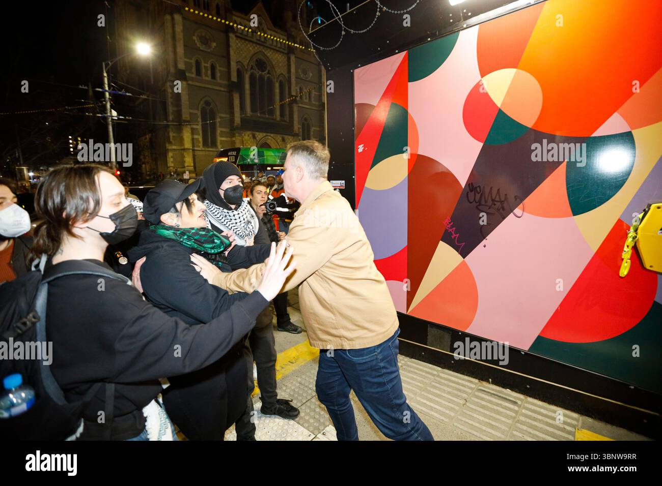 A local resident pushes a protester during the demonstration ...