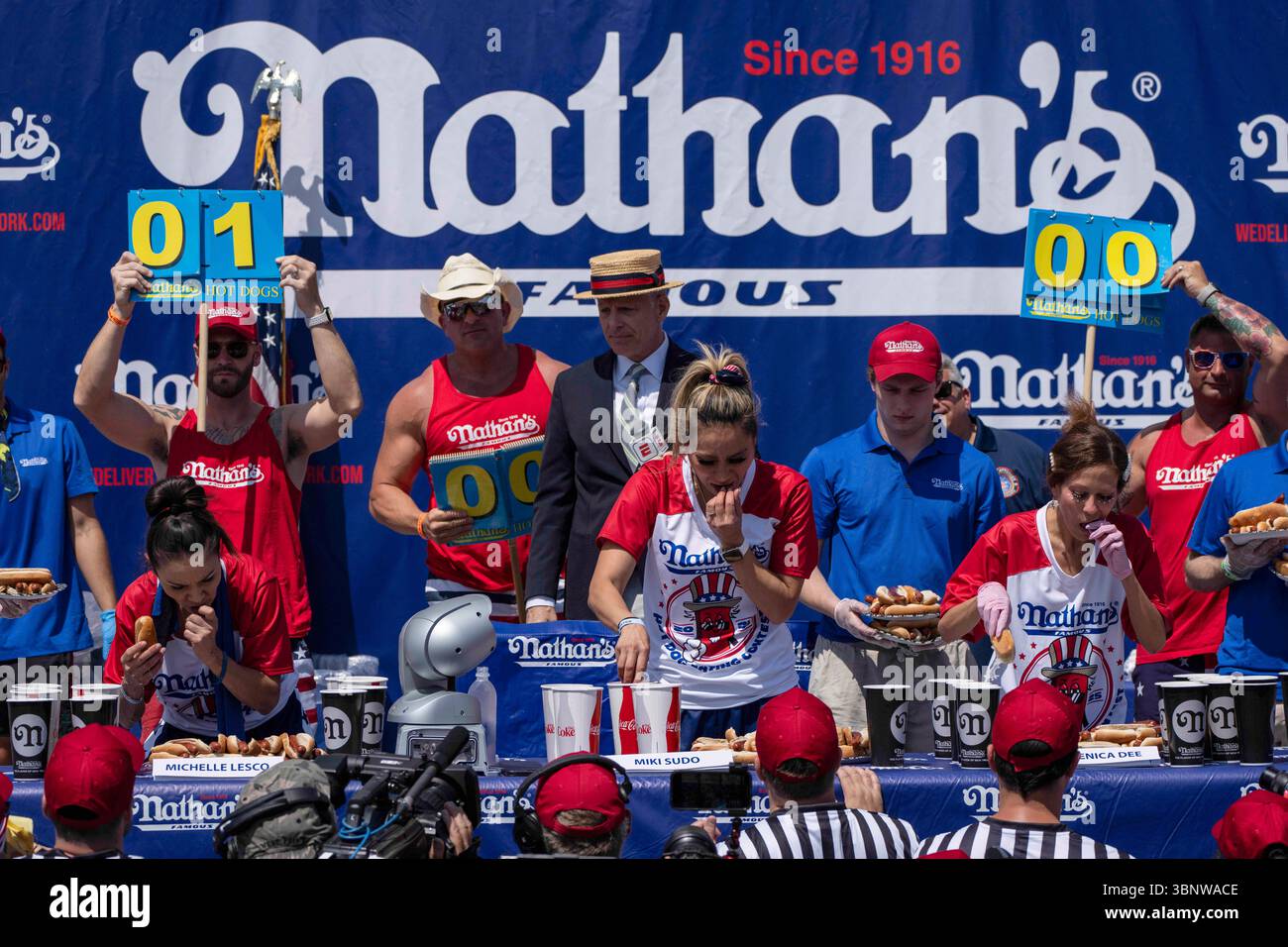 Competitive eaters eat hot dogs during the 2025 Nathan's Famous Fourth ...