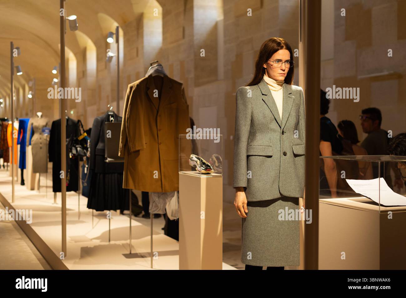 Visitors walk through the Balenciaga exhibition. The event showcases ...