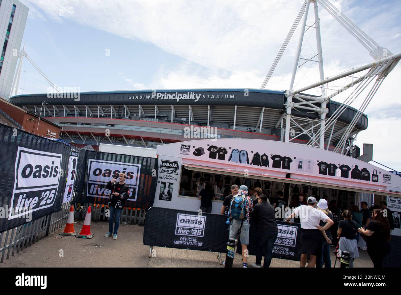 Cardiff, Wales, UK. 4th July, 2025. Oasis fans at an official merchandise stand in Cardiff city ...