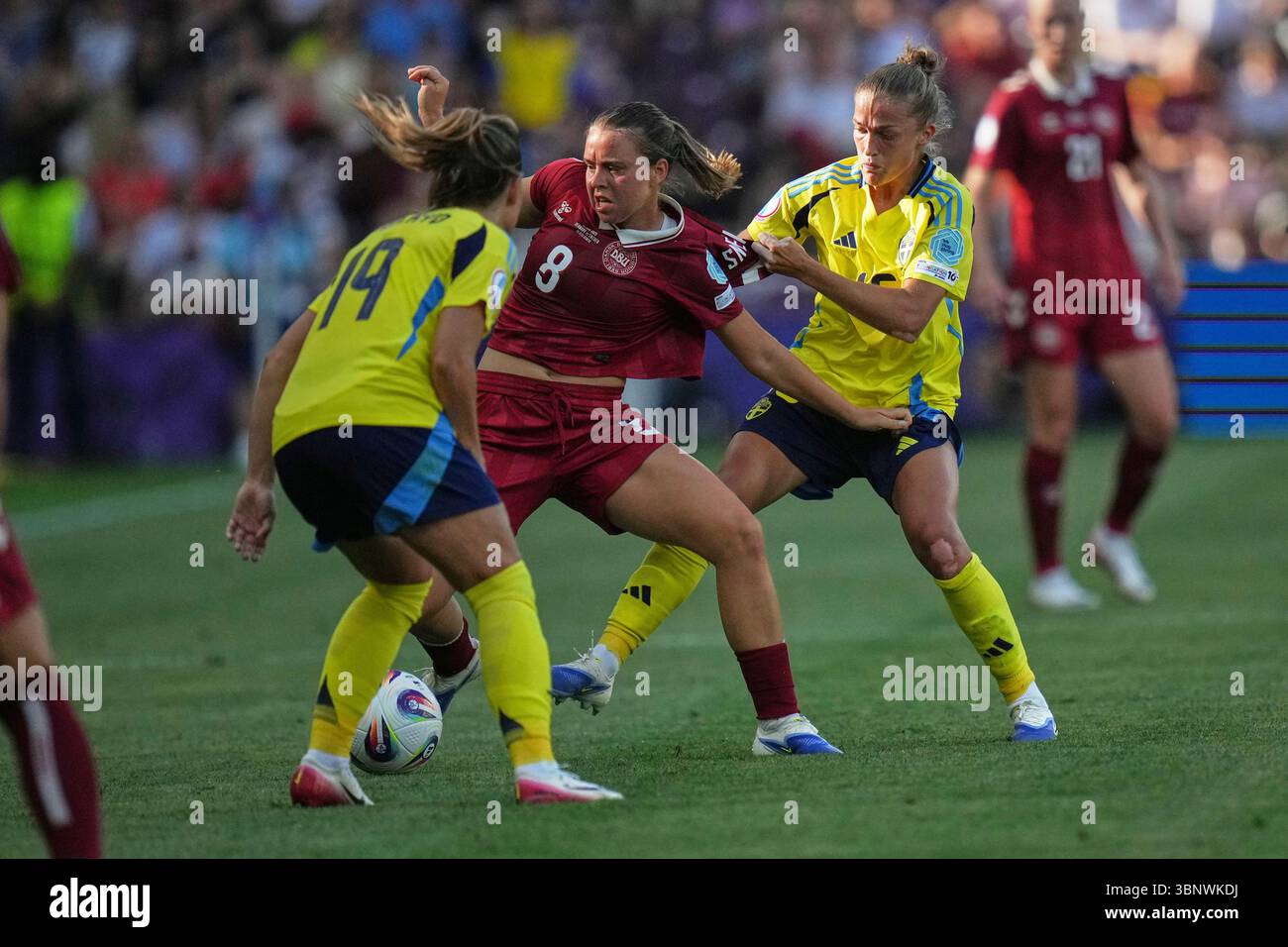 Denmark's Emma Snerle, center, challenges for the ball with Sweden's ...