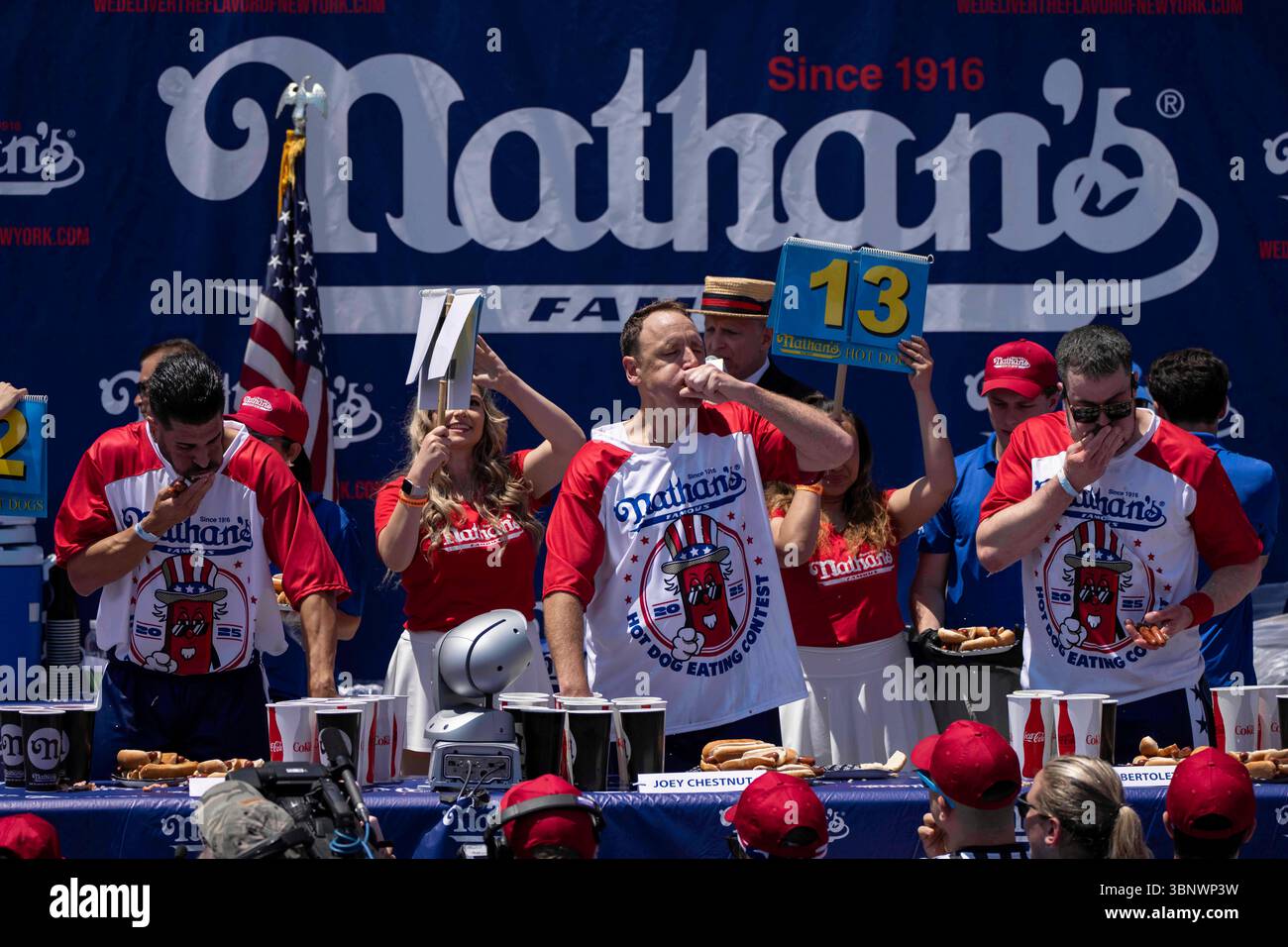 Competitive eaters eat hot dogs during the 2025 Nathan's Famous Fourth ...