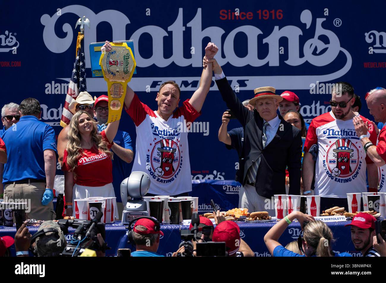 Competitive eater Joey Chestnut celebrates after winning the 2025 ...