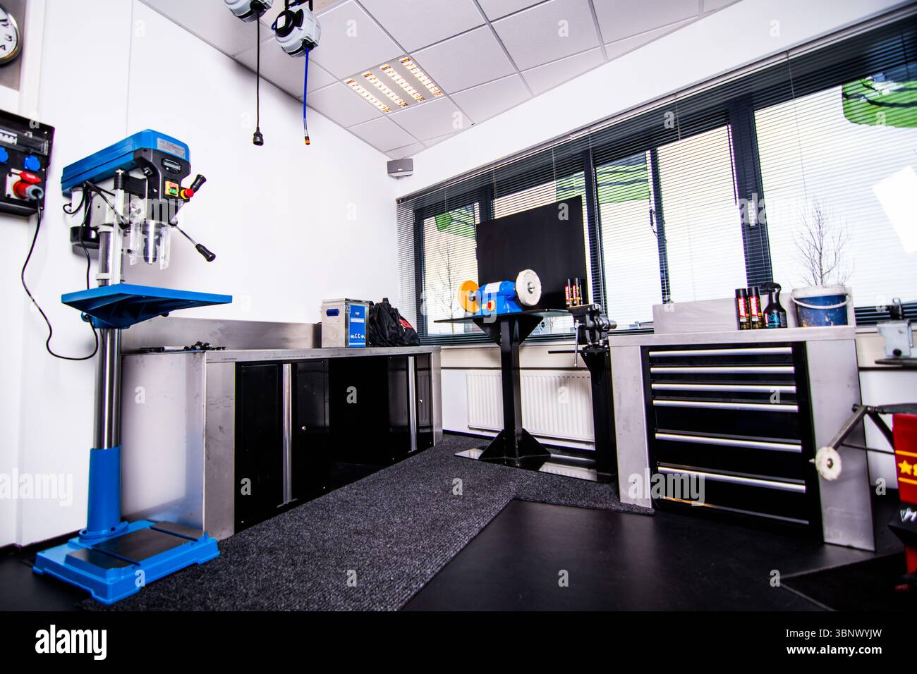 An organized workshop interior featuring various tools, workbenches ...