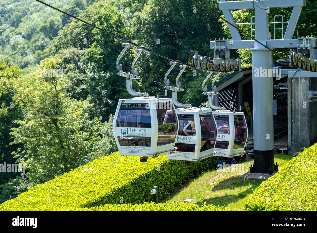 Matlock Bath, Derbyshire, UK – June 18 2025. Cable cars embarking on ...