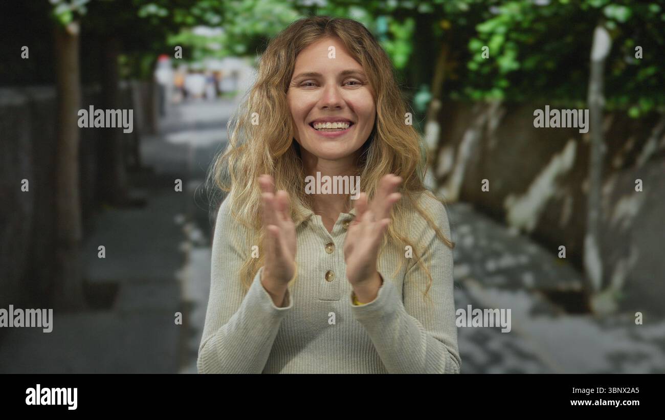 Woman raises hands clapping on hi-res stock photography and images - Alamy