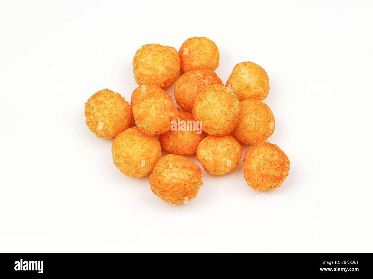 Pile of organic millet balls. Orange puffy snack isolated on white ...