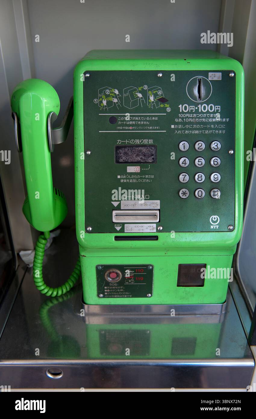 Japanese green NTT coin or phone card operated public telephone is a ...