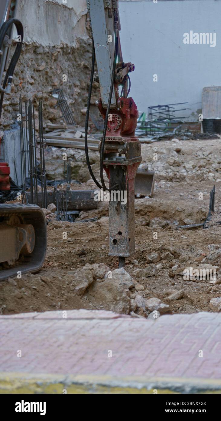 Construction excavator digging in an outdoor sunny setting shows ...