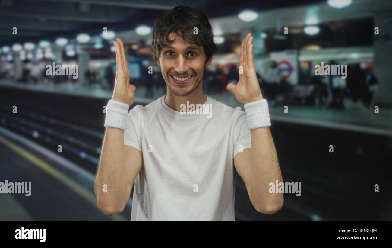 Man smiling broadly while using hands to frame view at a crowded ...
