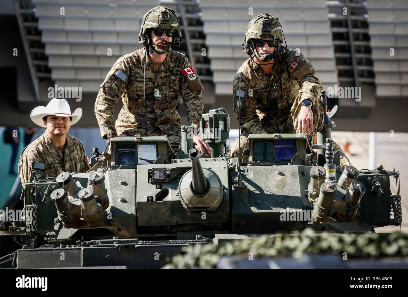 Members of the Canadian Armed Forces ride a light armoured vehicle ...