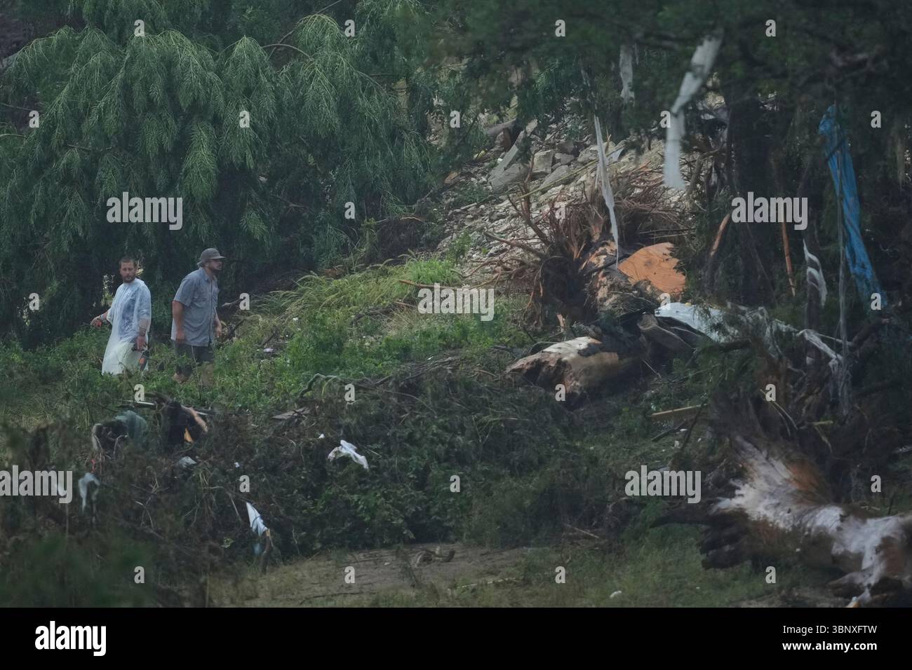Men survey damage left by a raging Guadalupe River, Friday, July 4 ...