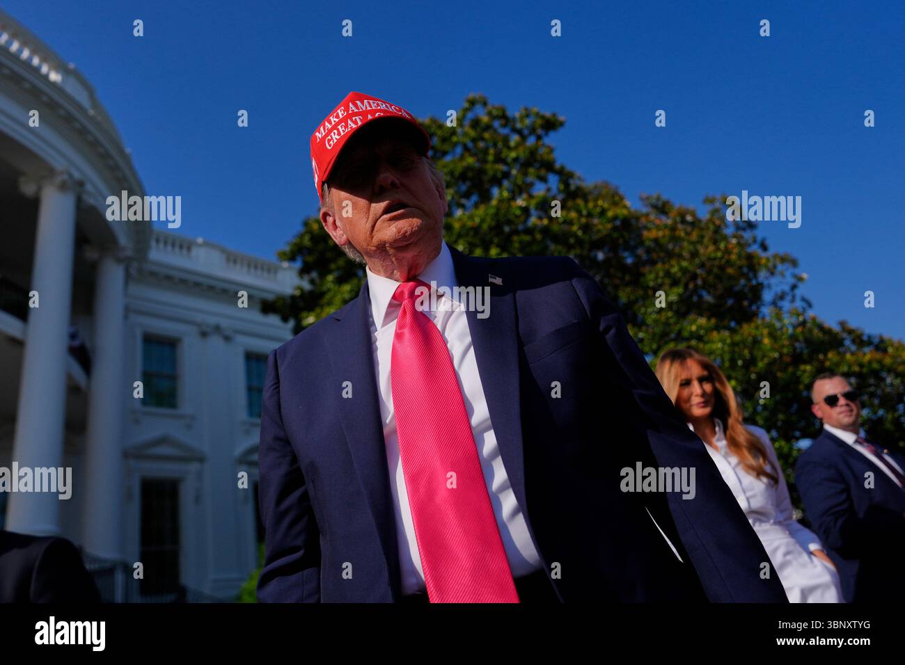 President Donald Trump walks to greet guests after he signed his ...