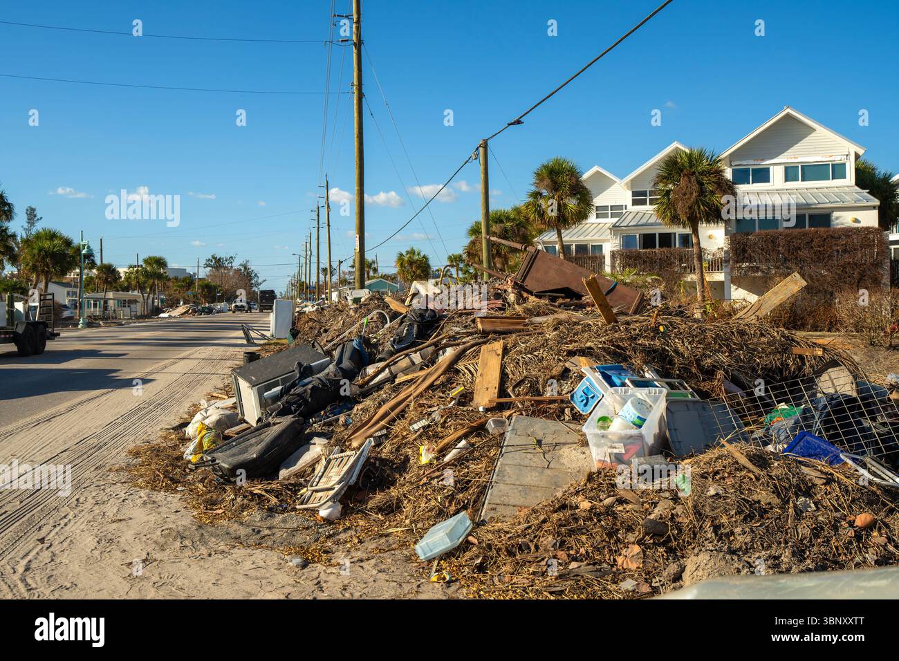 Cleanup efforts after hurricane in Florida. Piles of broken furniture ...