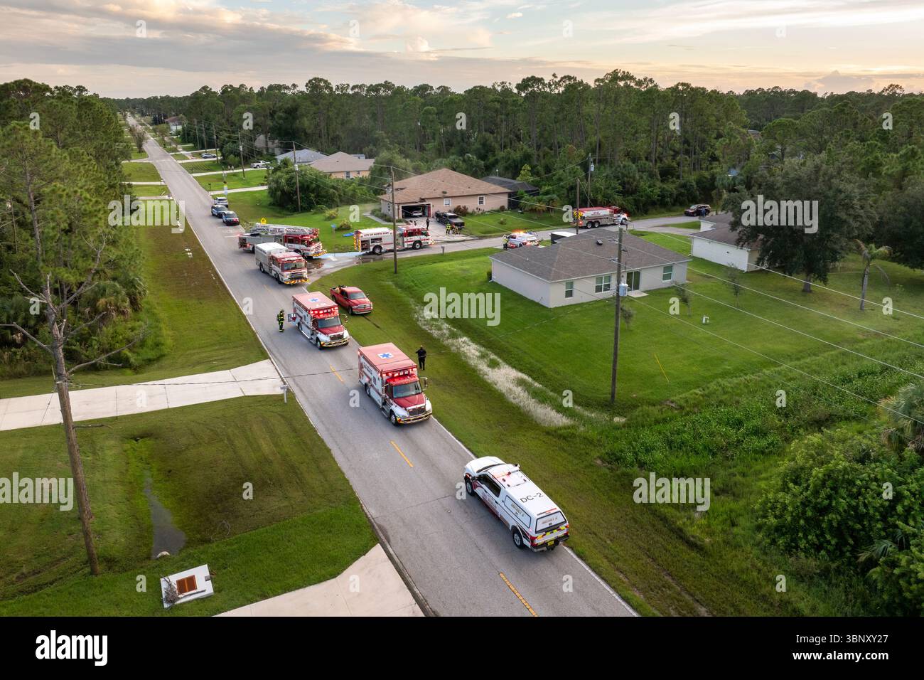 Firefighter trucks at fire alarm scene of suburban house. First ...