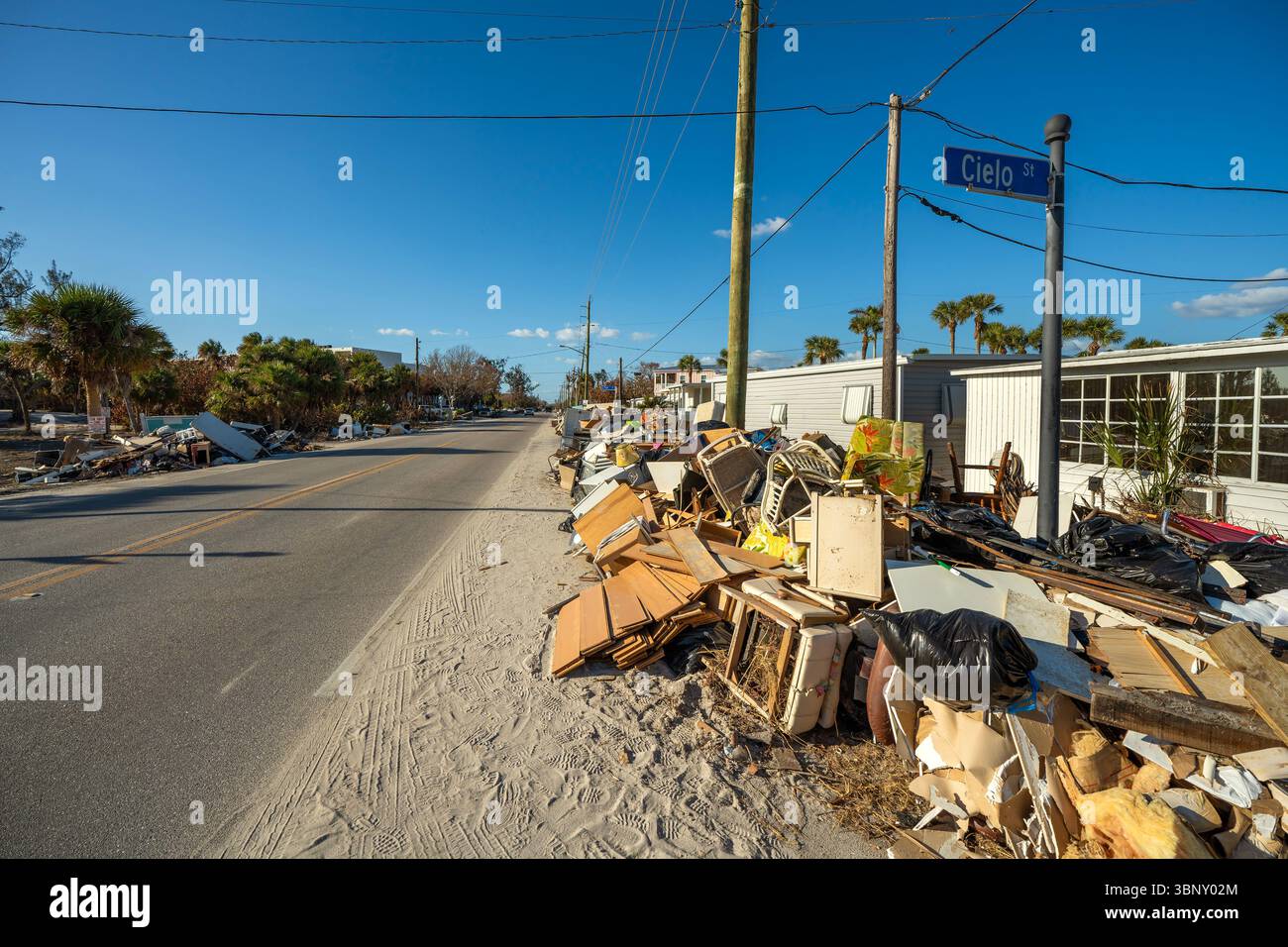 Rubbish and scrap disposed in heaps on street side after hurricane ...