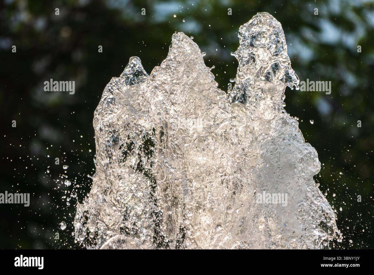 Water splashes from fountain on dark background. Natural texture of ...