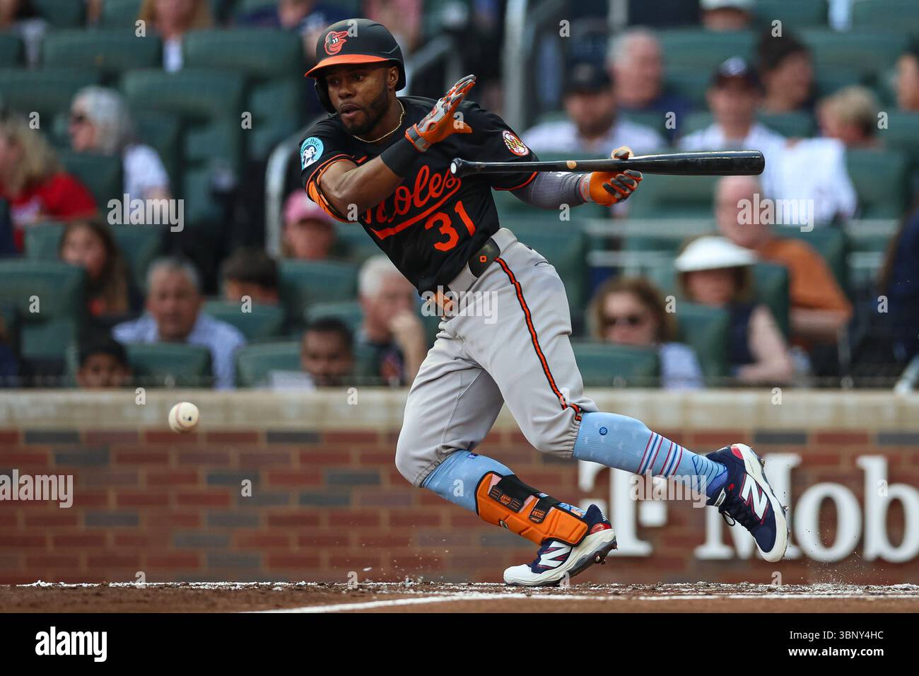 Baltimore Orioles' Cedric Mullins lays down a bunt in the third inning ...