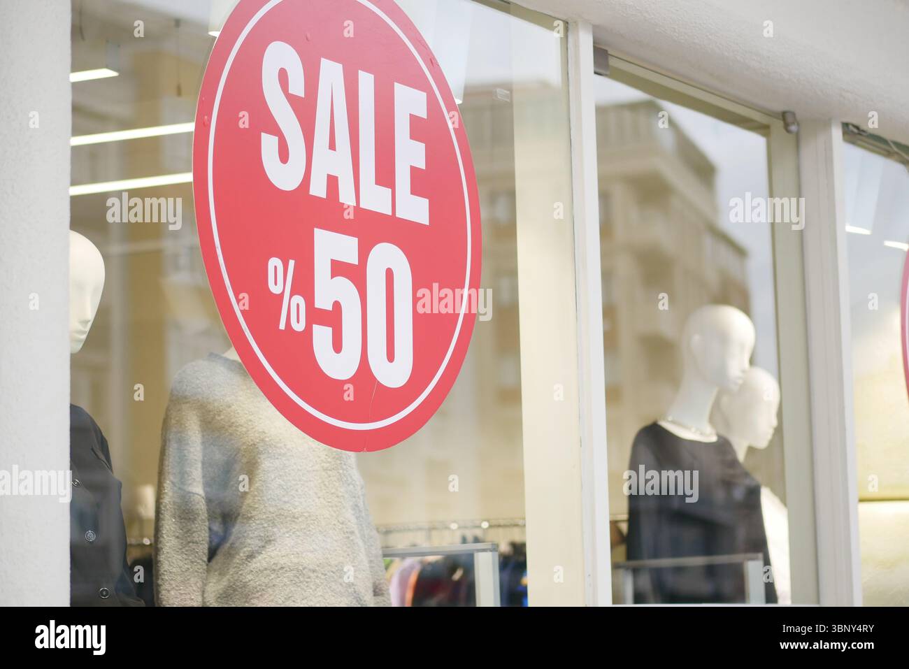 Sale sign in store window showcasing 50 percent discount Stock Photo ...