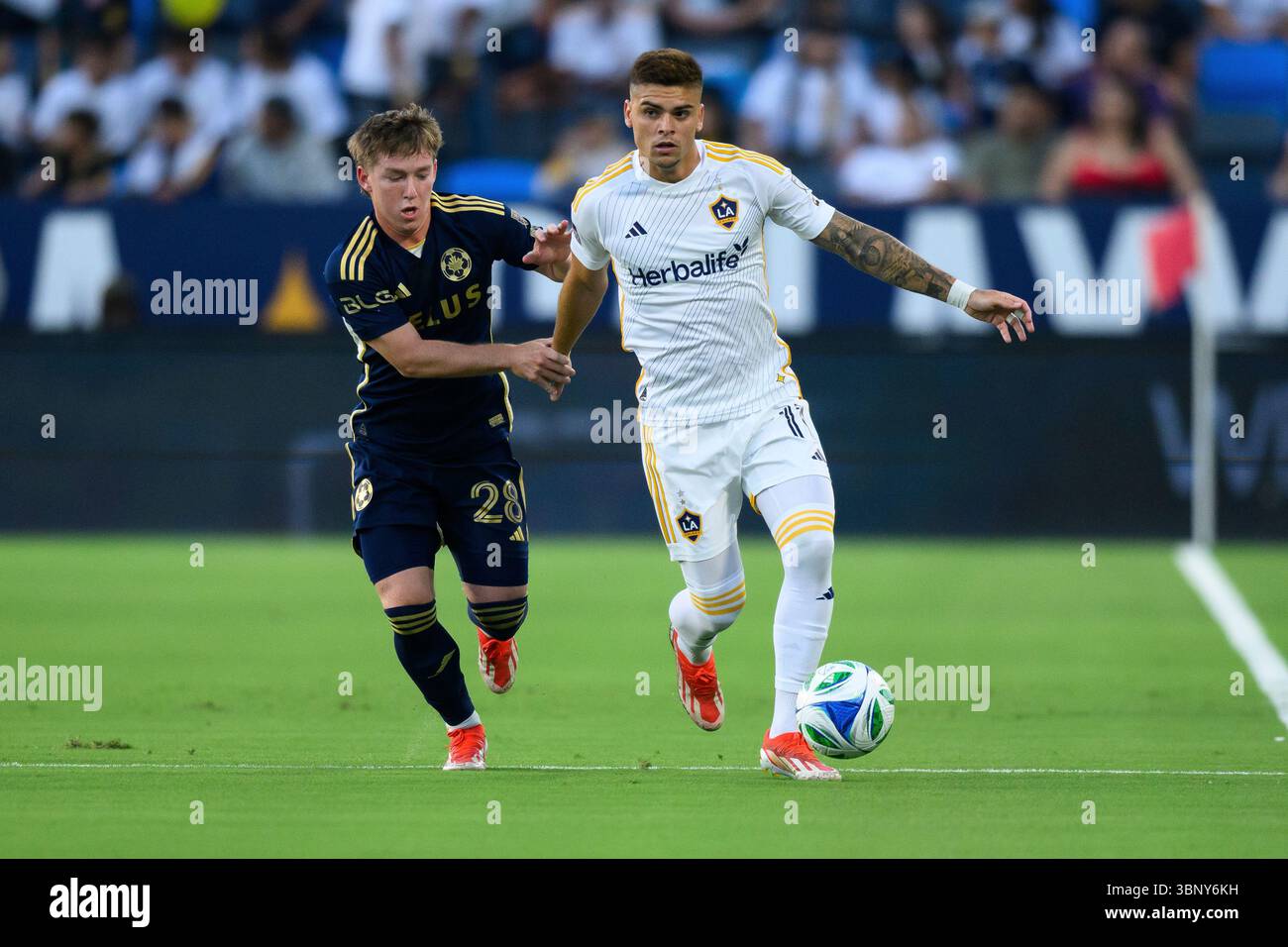 Los Angeles Galaxy forward Gabriel Pec, right, controls the ball while ...