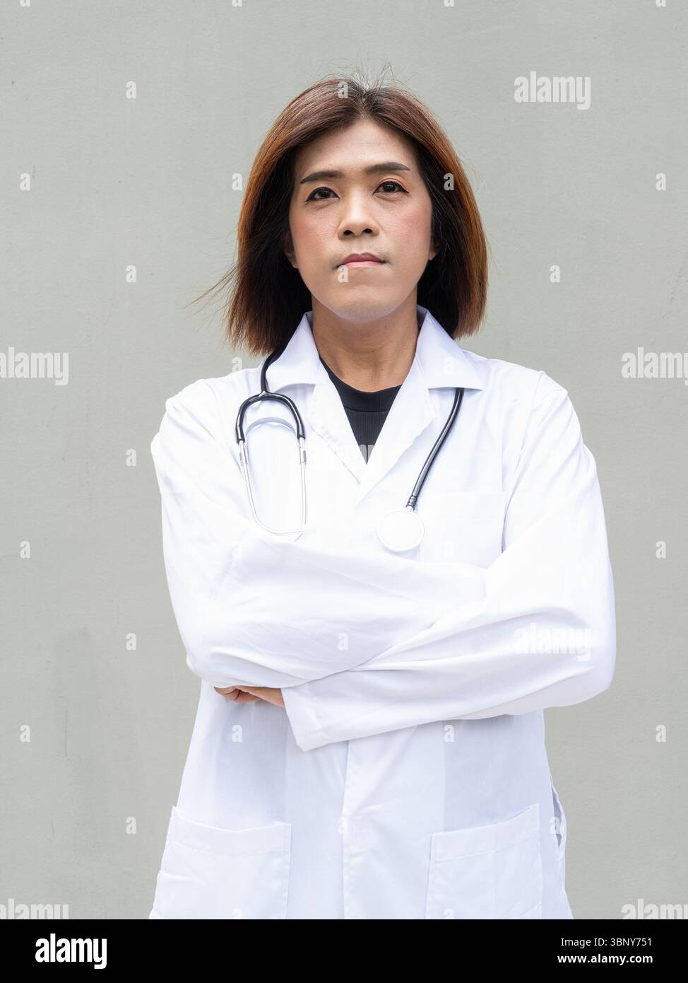Portrait of Asian transgender non binary doctor with stethoscope ...