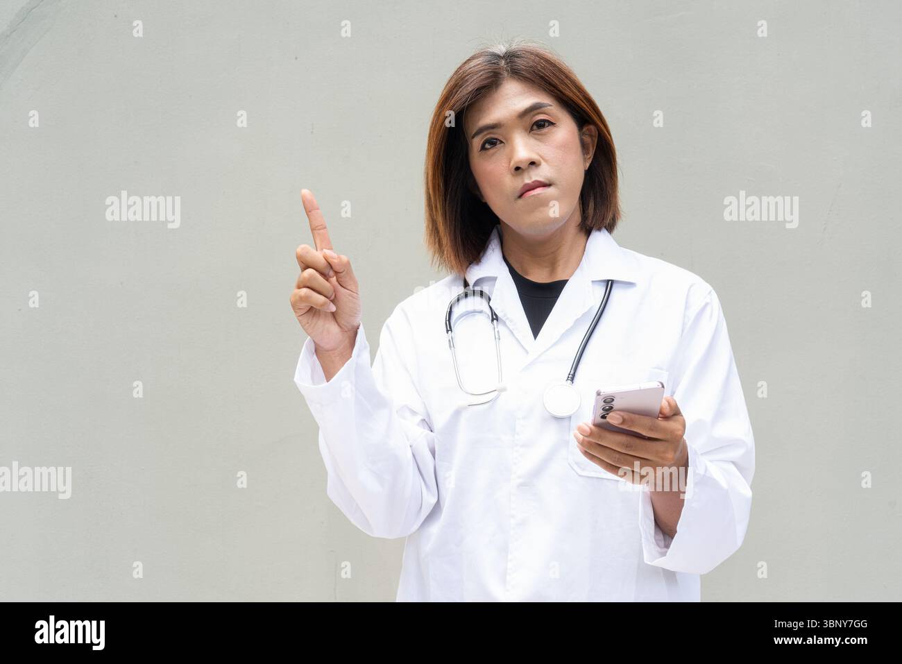 Portrait of Asian transgender non binary doctor with stethoscope ...
