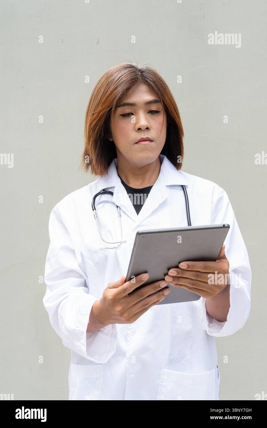 Portrait of Asian transgender non binary doctor with stethoscope ...