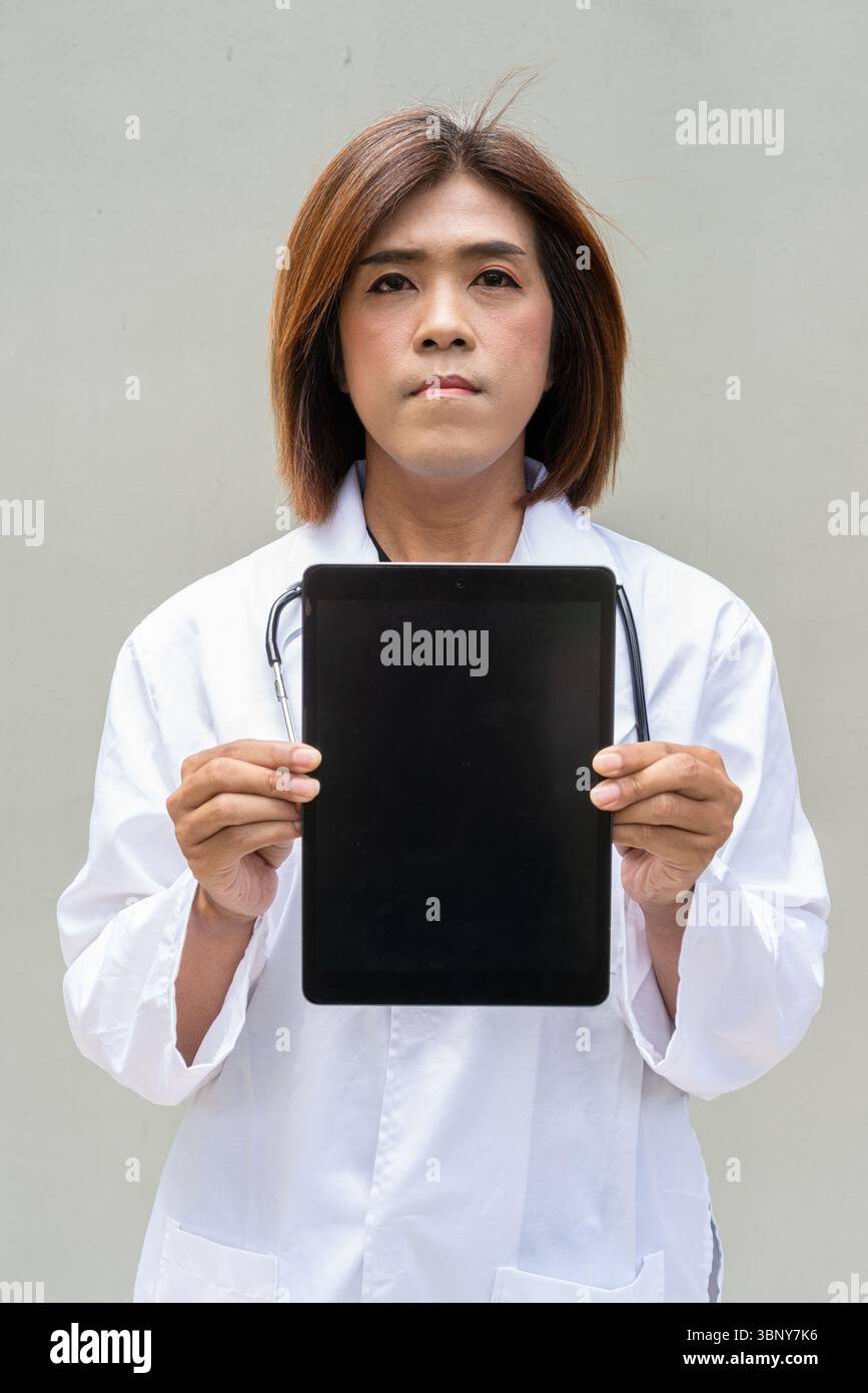 Portrait of Asian transgender non binary doctor with stethoscope ...