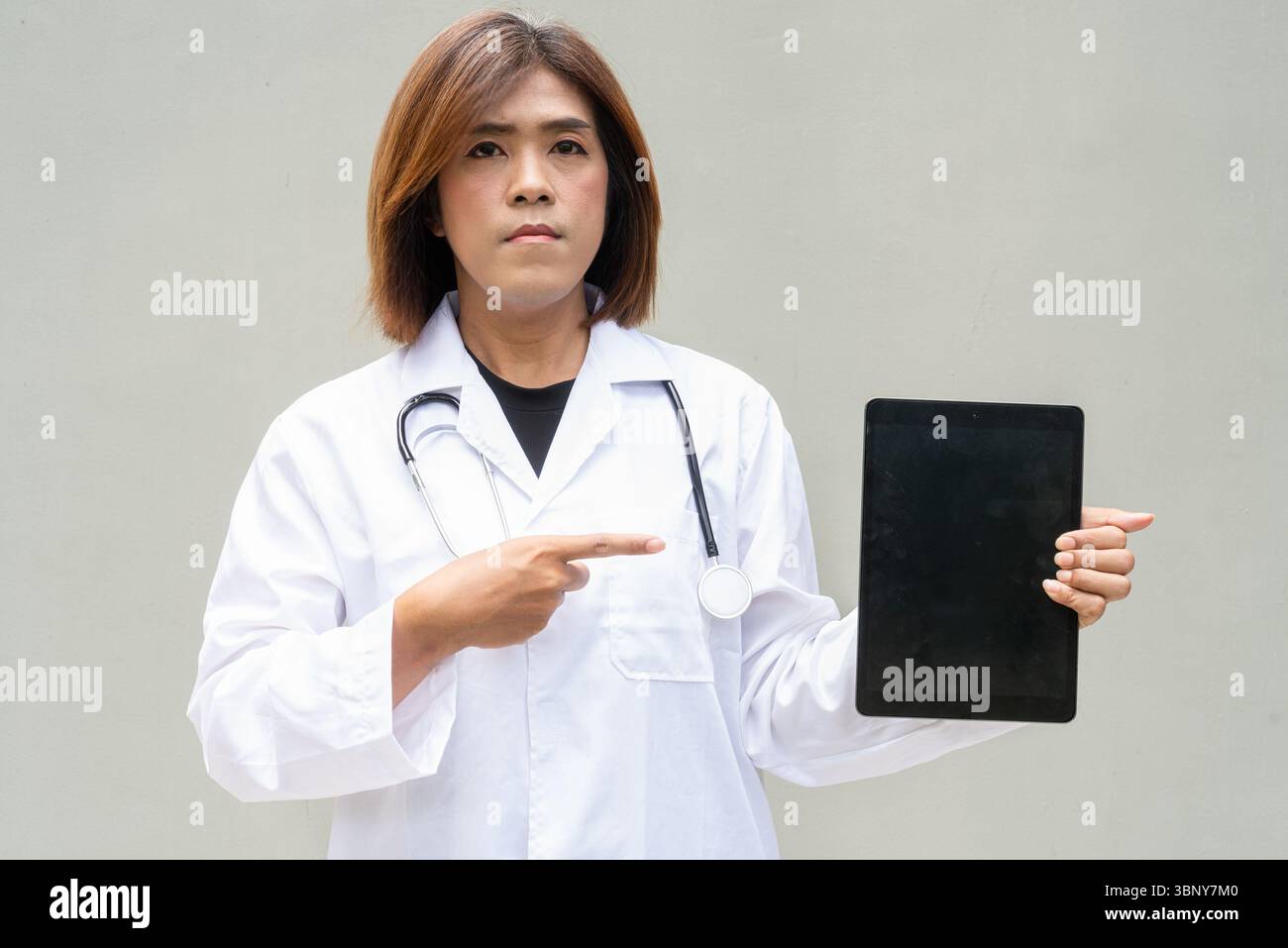 Portrait of Asian transgender non binary doctor with stethoscope ...