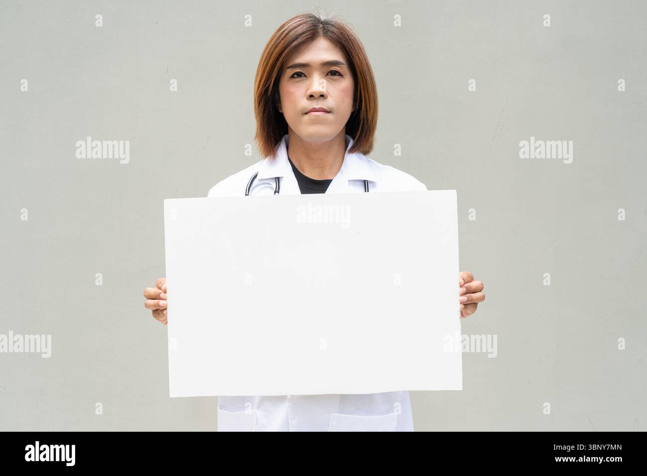Portrait of Asian transgender non binary doctor with stethoscope ...