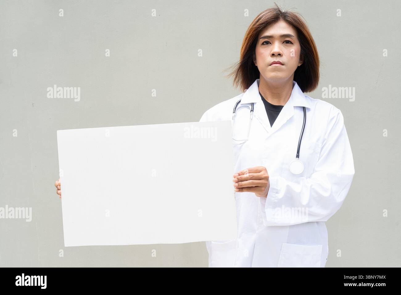 Portrait of Asian transgender non binary doctor with stethoscope ...