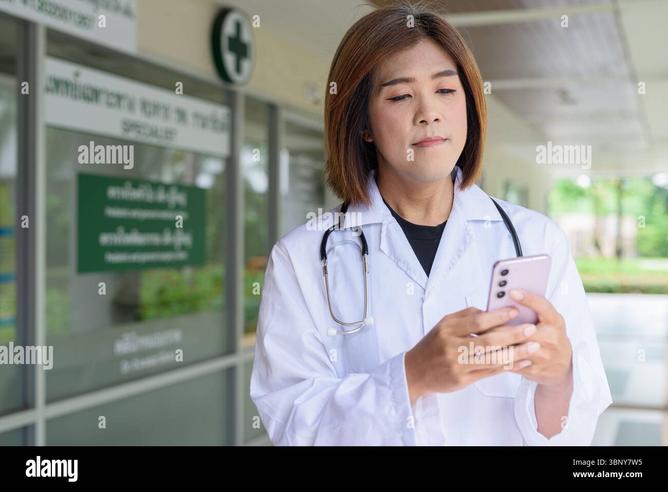 Portrait of Asian transgender non binary doctor with stethoscope ...