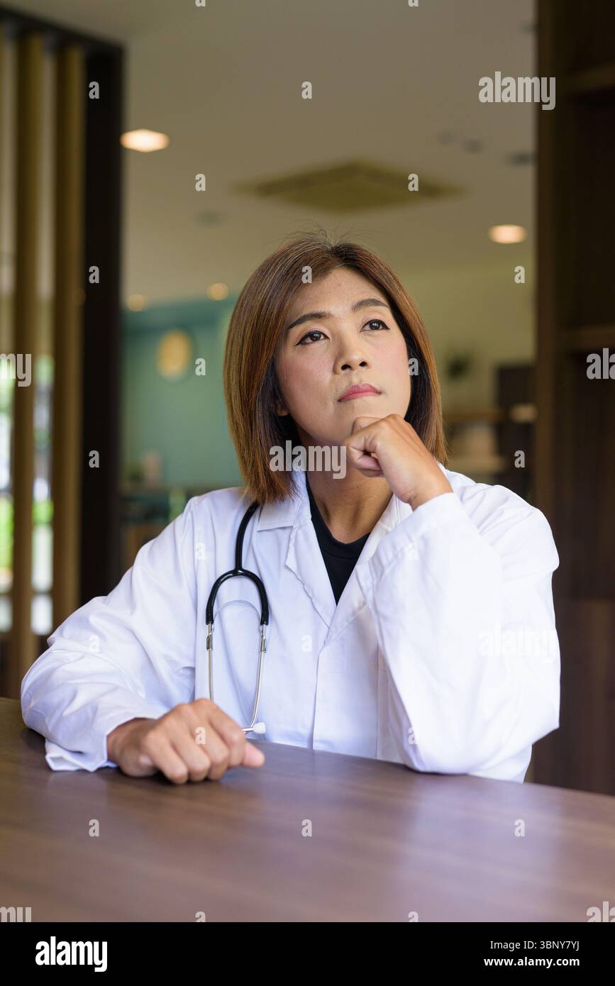 Portrait of Asian transgender non binary doctor with stethoscope ...