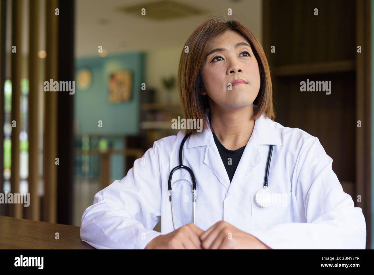 Portrait of Asian transgender non binary doctor with stethoscope ...