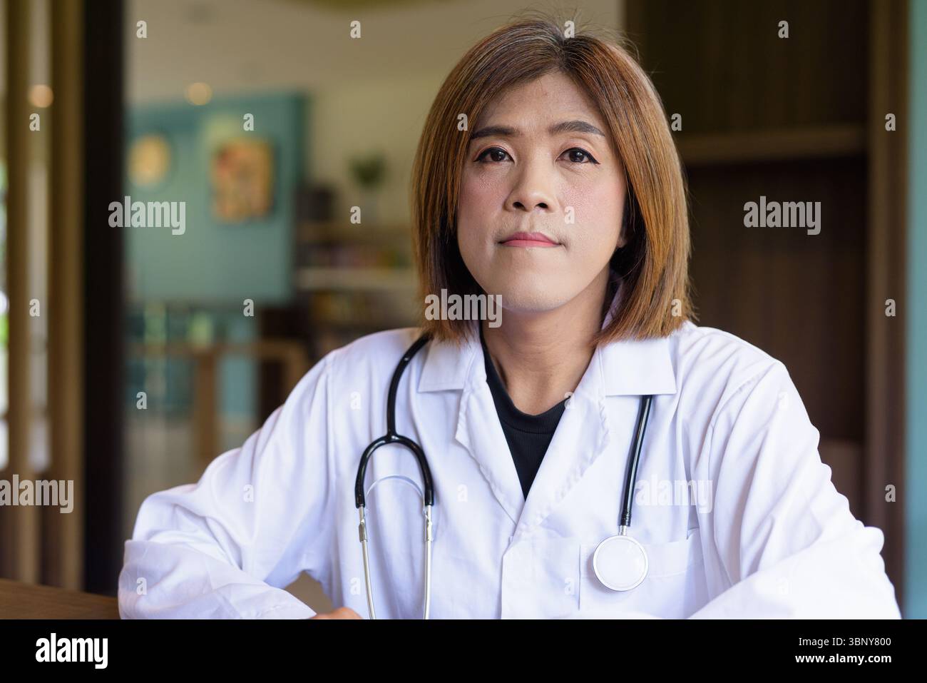 Portrait of Asian transgender non binary doctor with stethoscope ...