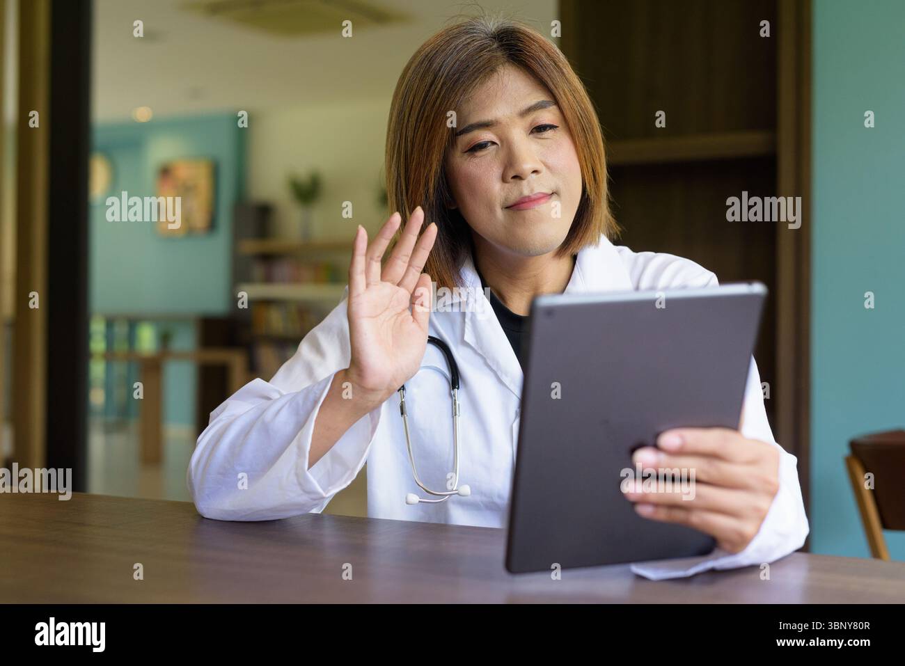 Portrait of Asian transgender non binary doctor with stethoscope ...