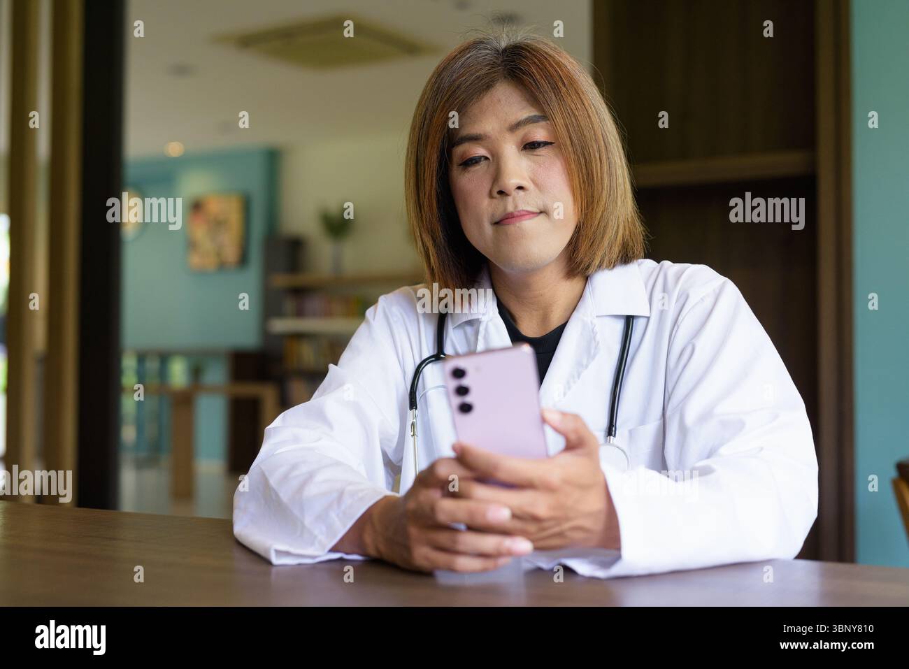 Portrait of Asian transgender non binary doctor with stethoscope ...