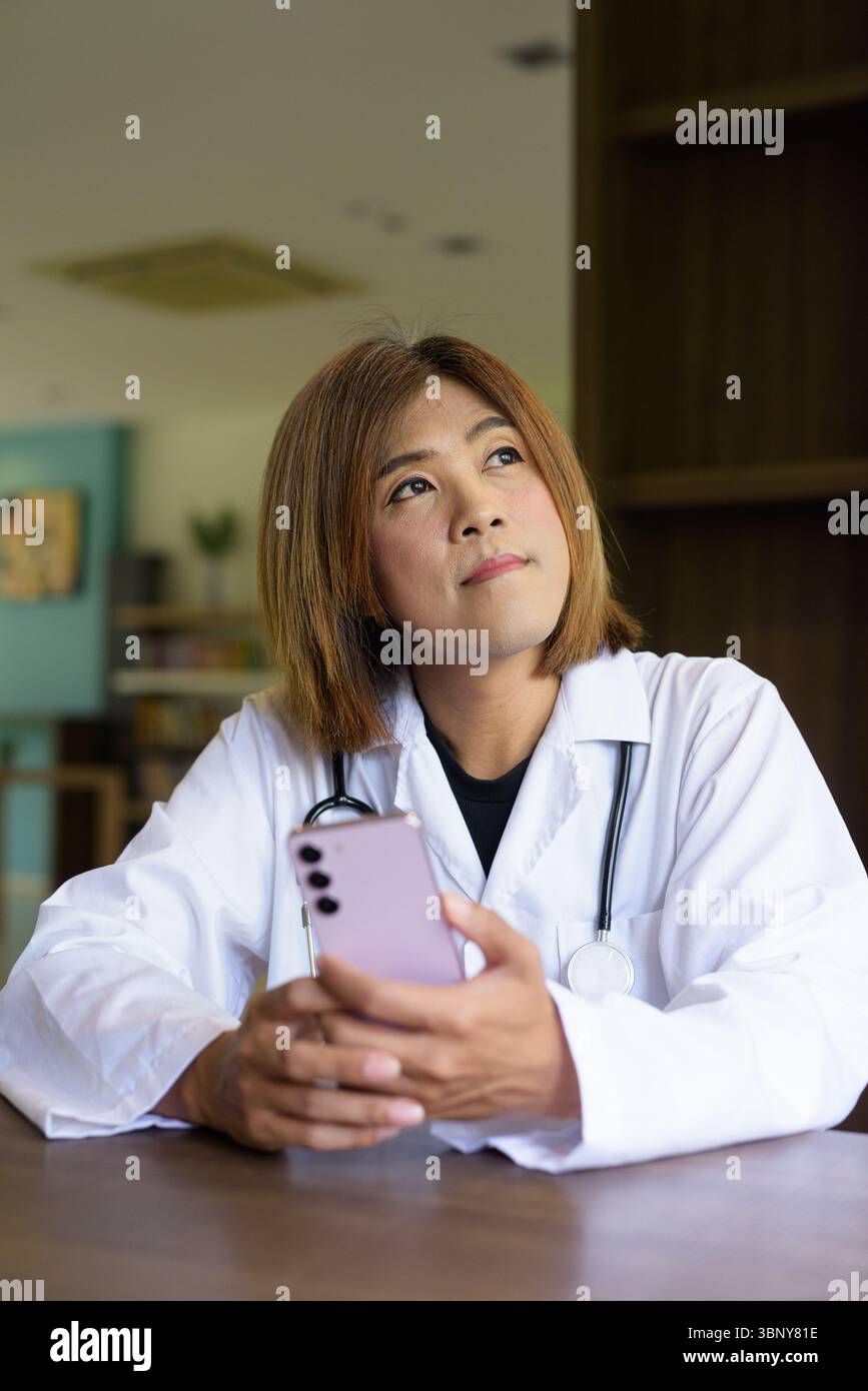 Portrait of Asian transgender non binary doctor with stethoscope ...