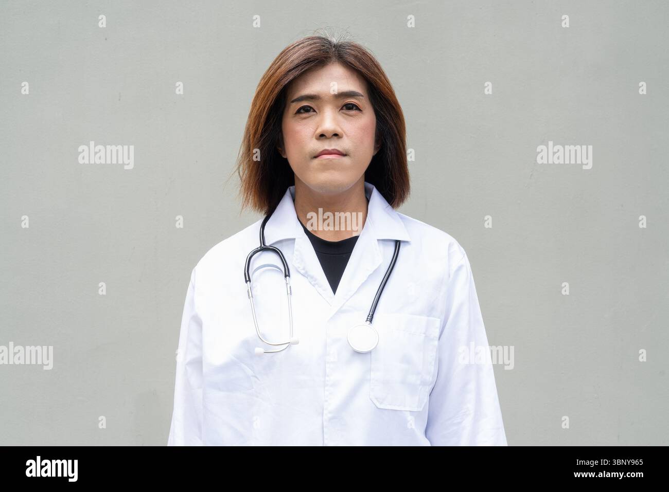 Portrait of Asian transgender non binary doctor with stethoscope ...