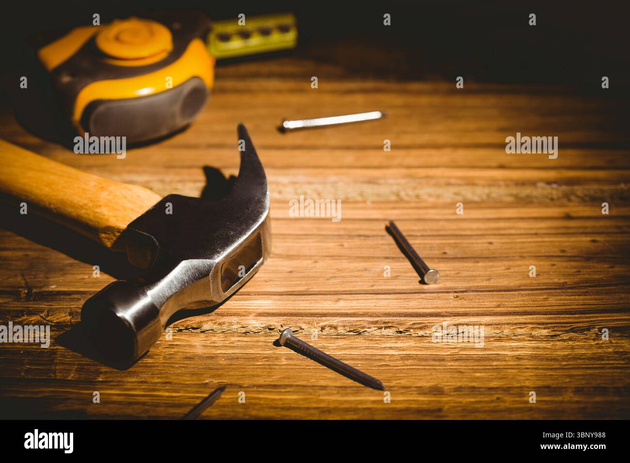 Flat design showing claw hammer lying on workbench, scattered nails ...
