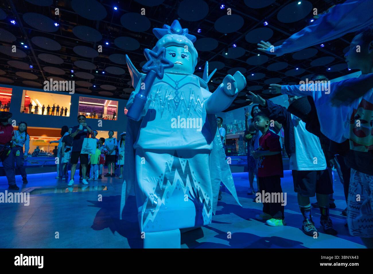 A Lego mascot character entertains visitors to Legoland Shanghai, China ...