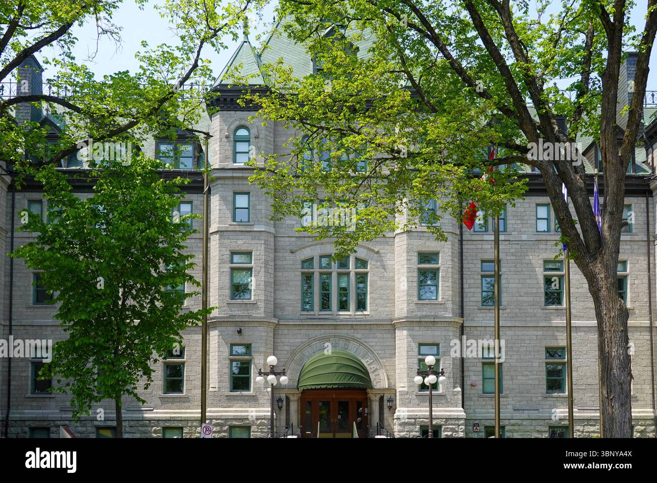 Matching historic stone building with symmetrical arched entrance and ...