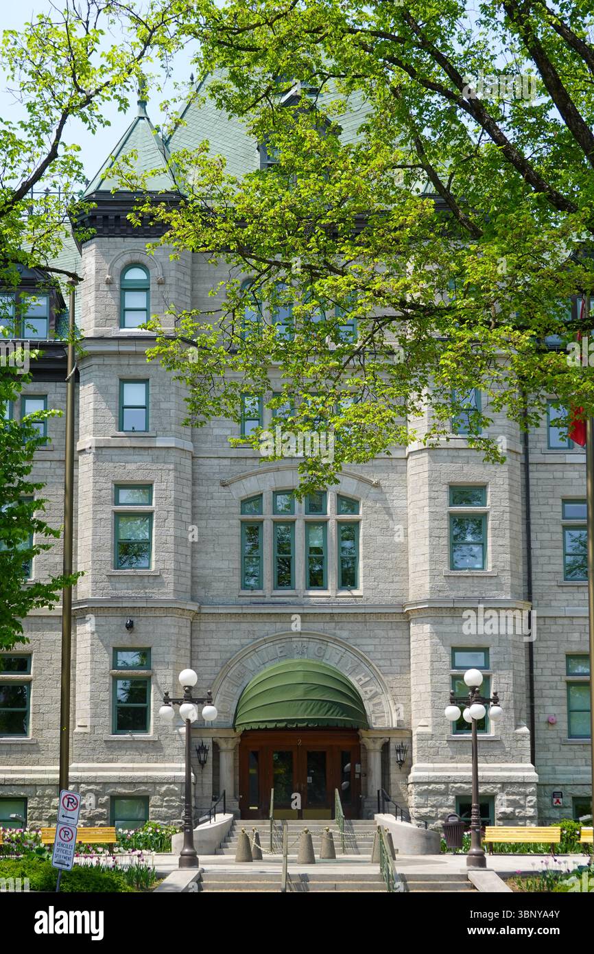 Historic stone building entrance with arched doorway and green awning ...