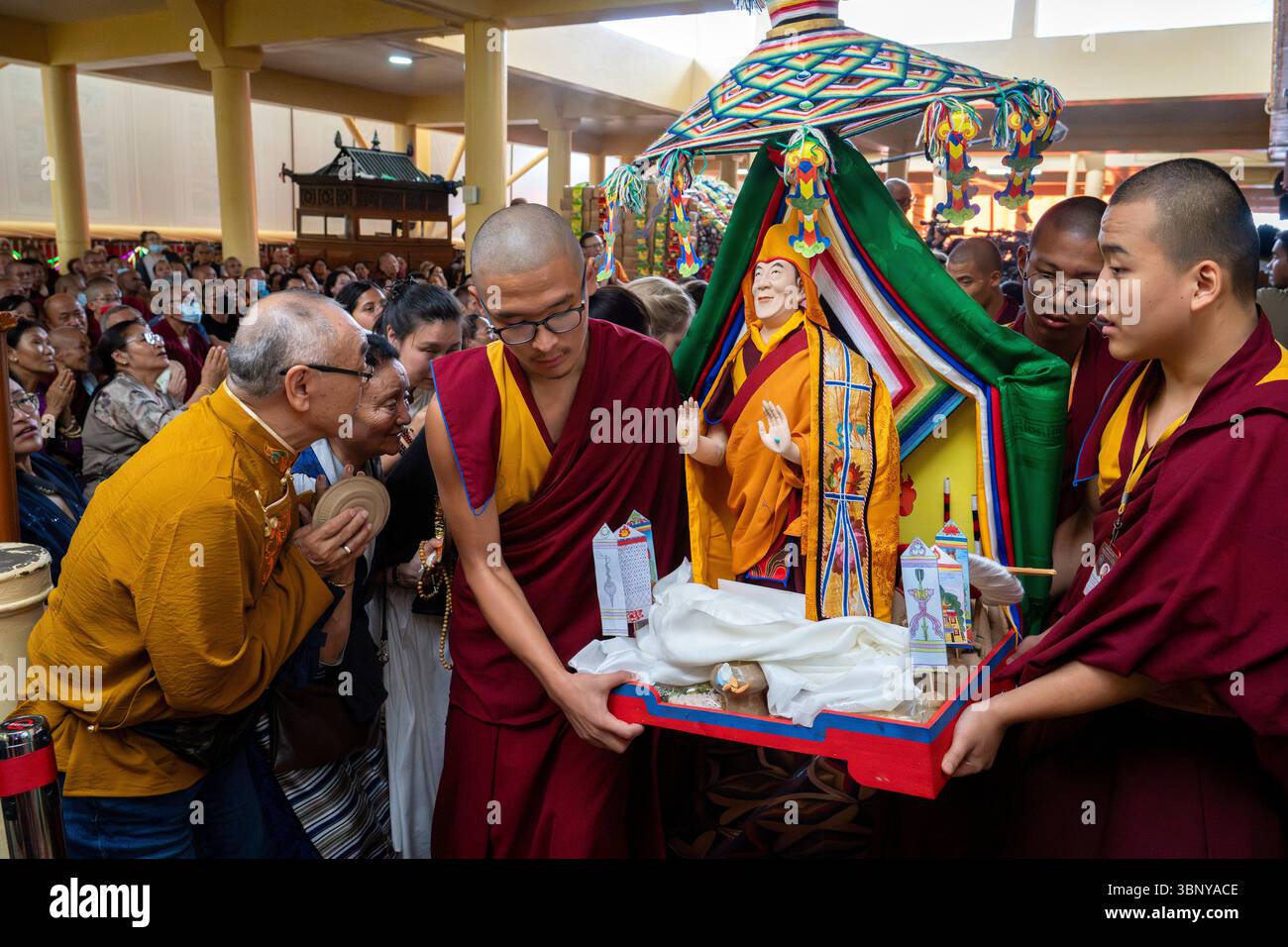 Exiled Tibetan Buddhist monks carry a sculpture representing Tibetan ...