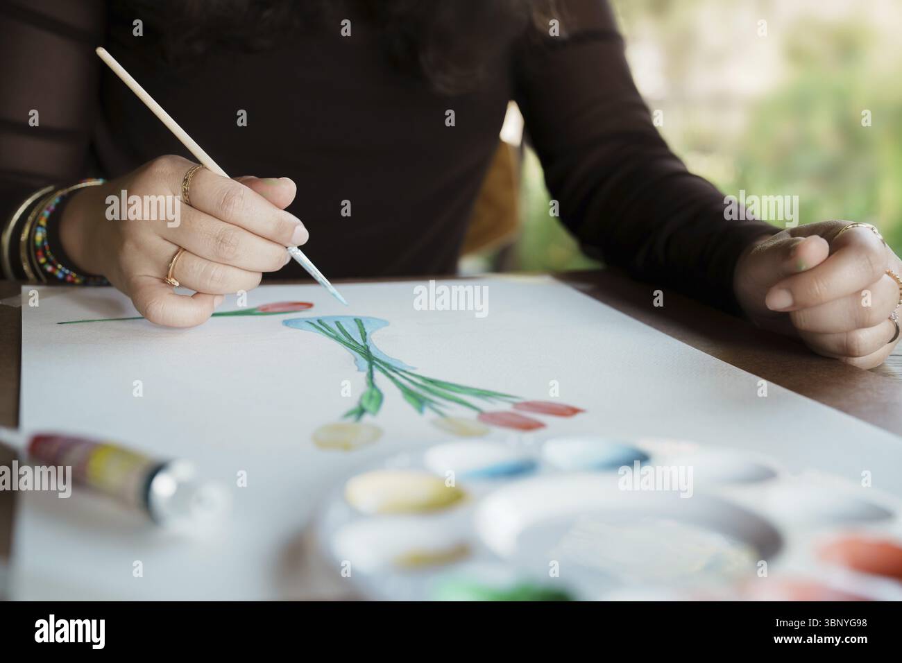 Young asian woman artist painting on canvas. Female artist drawing with ...